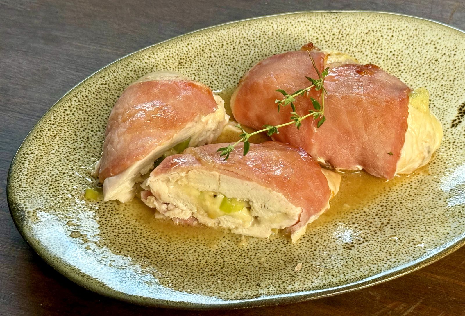 Bacon-wrapped chicken parcels stuffed with cheese and spring onion