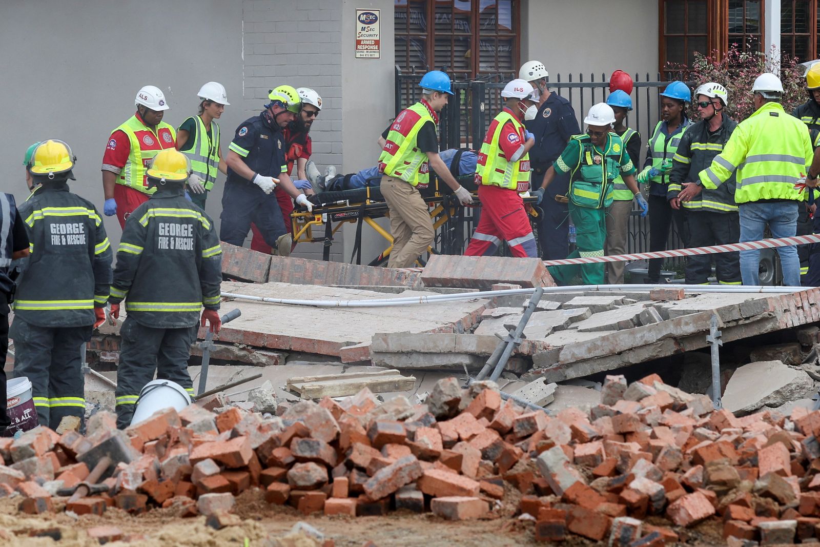 Frantic search for dozens missing in George building collapse