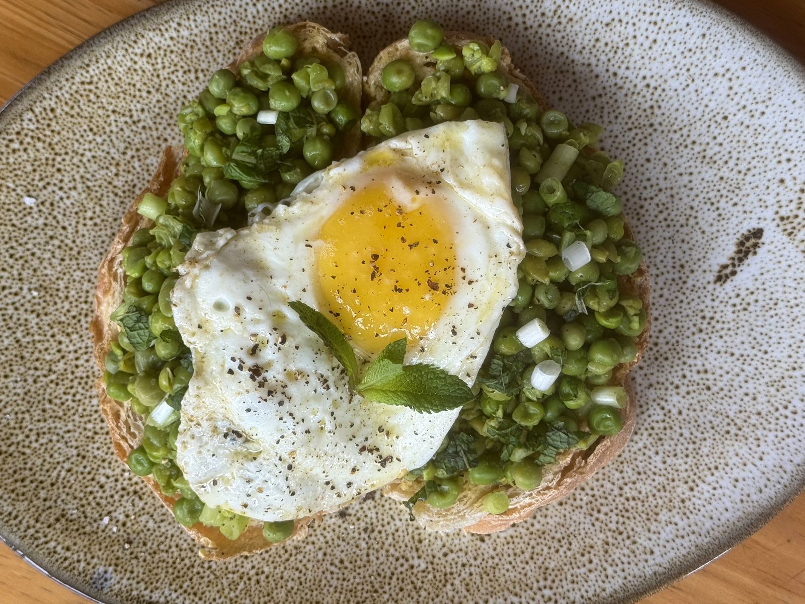 Smashed peas on toast with a fried egg